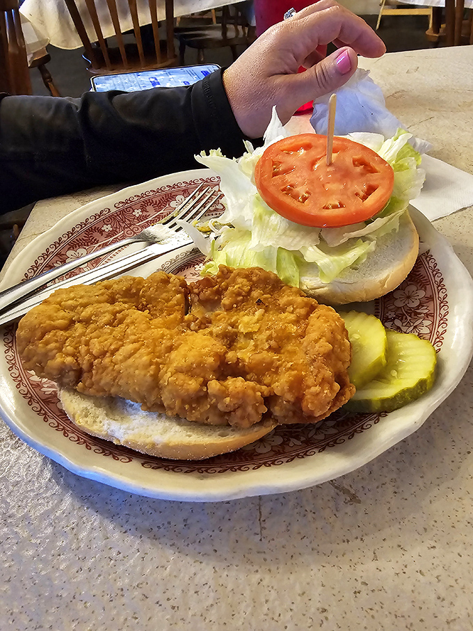 The chicken sandwich that launched a thousand road trips. Crispy, golden perfection on a pillowy bun with pickle sentinels standing guard against mundane lunches.