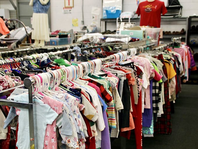 Tiny fashion statements hang in colorful rows, each onesie and sundress holding the promise of adorable photo opportunities and hand-me-down potential.