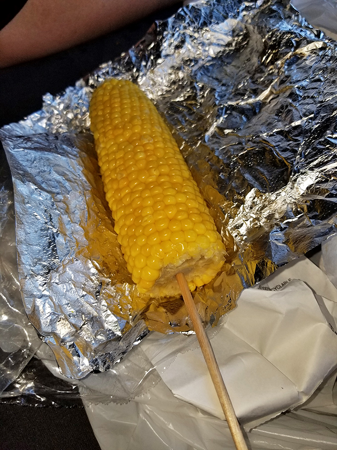 Corn on the cob wrapped in foil&mdash;nature's perfect side dish, ready to complement that crispy chicken with sweet, buttery simplicity.