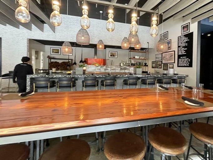 The raw bar counter—where oyster enthusiasts gather like scholars at a library of briny delights. Knowledge and mignonette sauce freely shared.