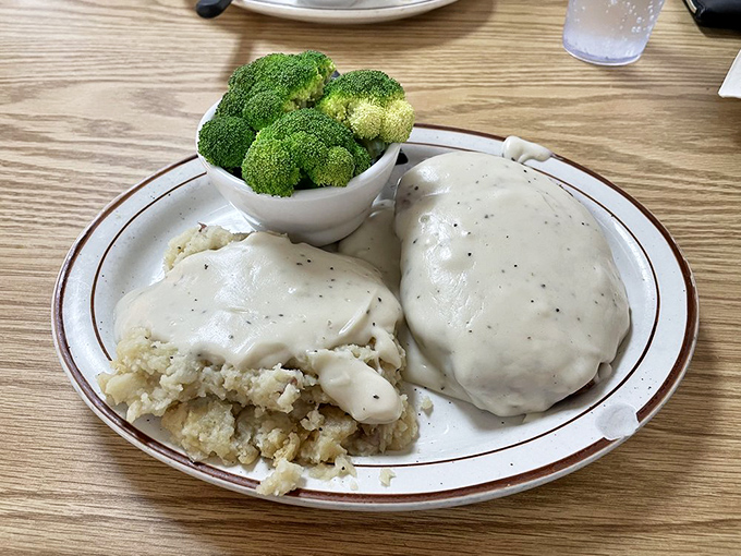 Country-fried comfort on a plate&mdash;tender meat beneath creamy gravy alongside mashed potatoes that clearly never came from a box.