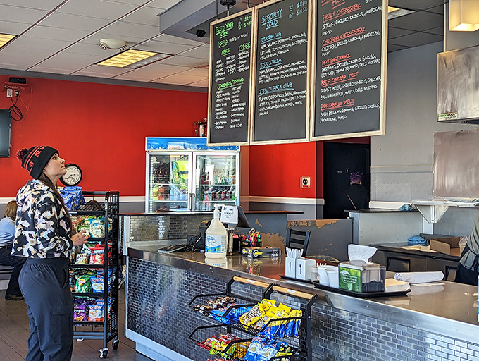 The universal posture of the hungry customer—studying the menu like it's the final exam for a class you actually care about.