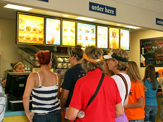 The universal language of anticipation&mdash;hungry visitors studying the menu like it's a treasure map to flavor paradise.