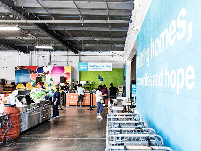 The bustling heart of the ReStore, where staff help treasure-hunters navigate their quest. Every purchase here builds more than just your home.