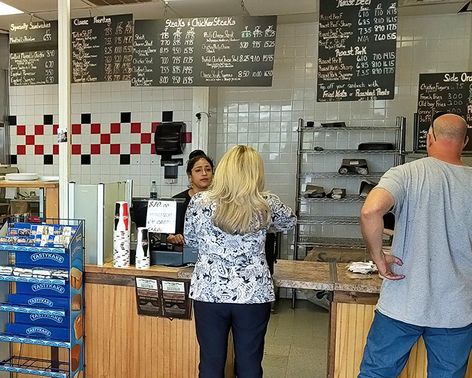 The chalkboard menu and ordering counter create that perfect old-school sandwich shop vibe that no amount of modern design could replicate.