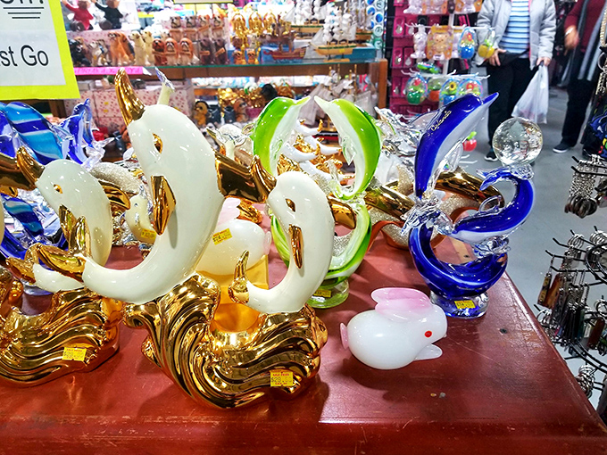 Glass swans glide elegantly across display tables, their gold-accented forms bringing a touch of vintage glamour to modern homes.