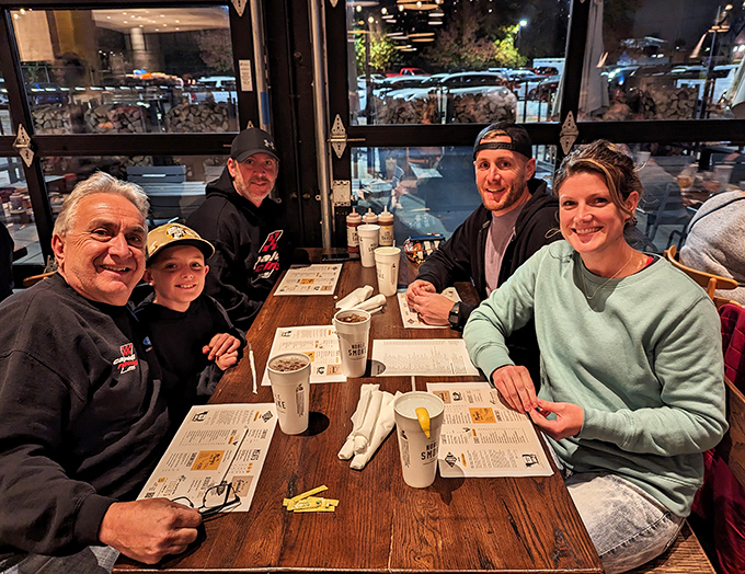 Happy faces around a table of barbecue&mdash;the universal language of "we made the right decision coming here today."
