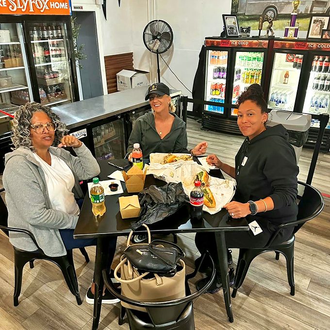 Three satisfied souls sharing a moment of pure cheesesteak bliss &ndash; this is what happiness looks like.