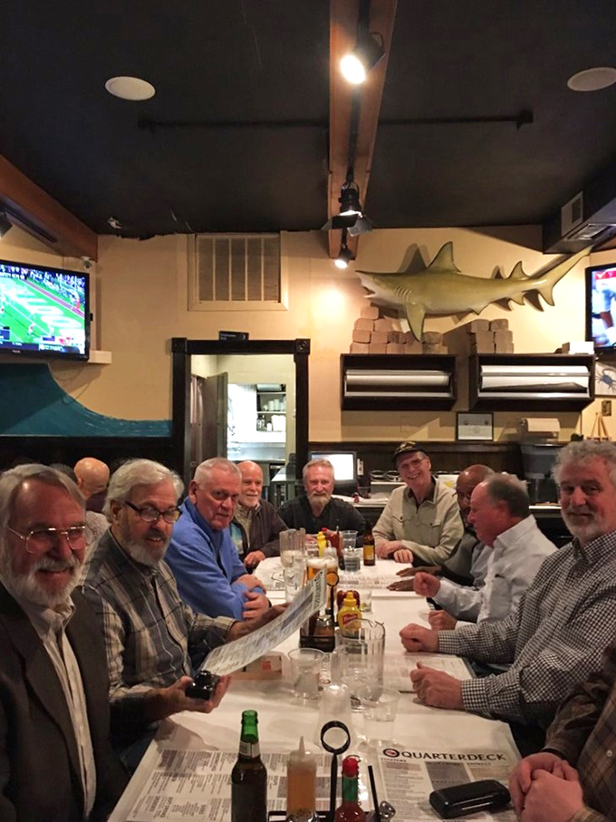 A gathering of friends around a paper-covered table, proving that the best dining experiences are equal parts food and fellowship.
