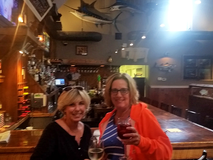 The universal expression of "this was absolutely worth the drive" captured at the bar. Two friends celebrating the discovery of Delaware's coastal treasure.