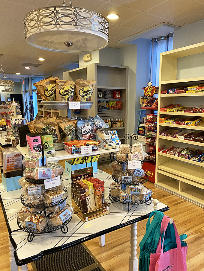 Tiered displays of nostalgic treats create an obstacle course for your willpower. The shopping bags stand ready for inevitable surrender.