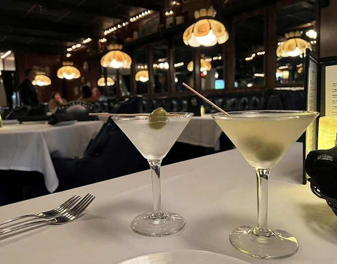 Classic martinis waiting patiently at a white-clothed table&mdash;the perfect prelude to an evening of culinary nostalgia.