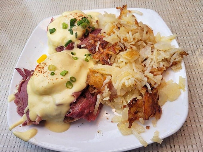 Eggs Benedict with a twist: perfectly poached eggs and hollandaise draped over corned beef and crispy potatoes. Morning luxury achieved.