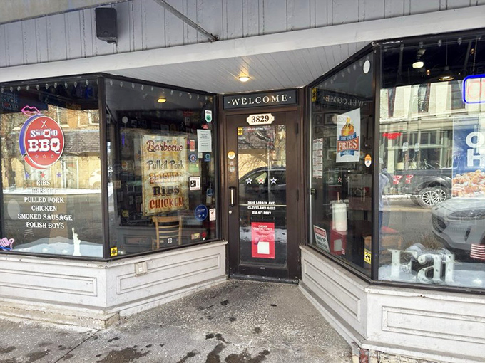 "Welcome" indeed. This corner entrance has seen countless BBQ pilgrims enter hungry and leave transformed. The windows promise ribs, chicken, and salvation.