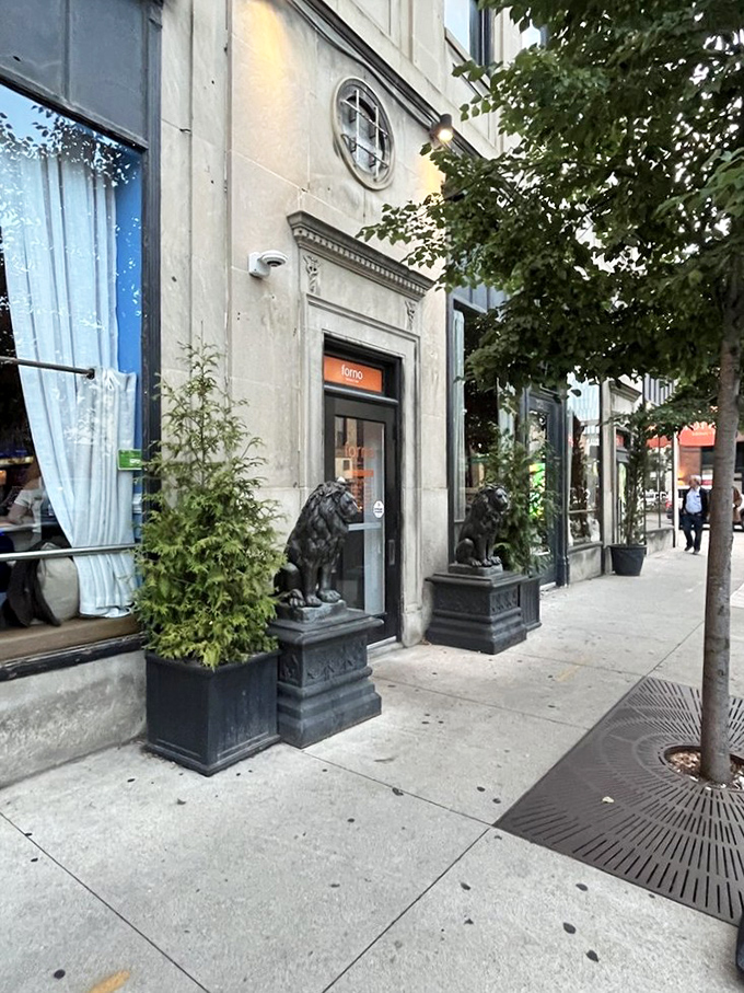 Stately lion sculptures guard the entrance like they're protecting the secret to perfect pizza crust. This isn't just a doorway&mdash;it's a portal to flavor town.