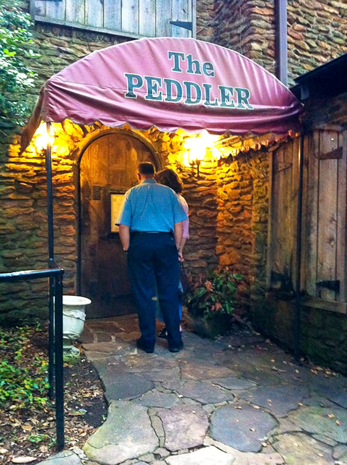 The entrance beckons with warm lighting and that iconic burgundy awning&mdash;like being invited to dinner at a friend's cottage, if your friend were a steak wizard.