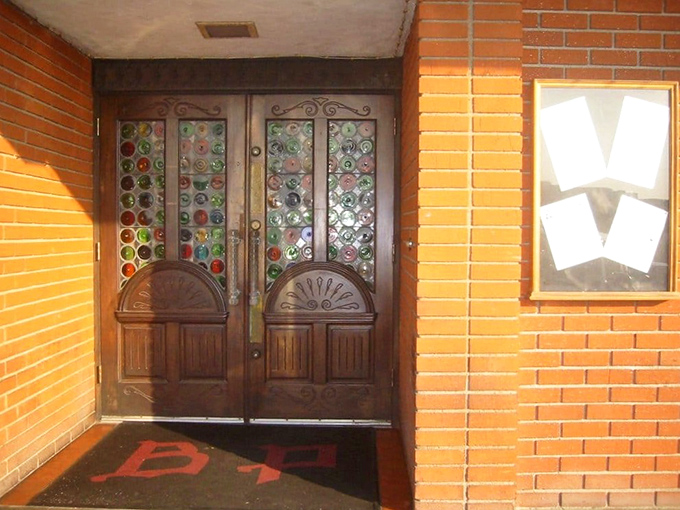 Those stained glass doors aren't just an entrance; they're a portal to a time when dining out was an occasion and calories weren't counted.