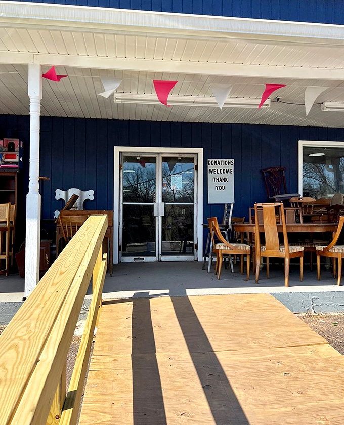 The welcoming entrance with its cheerful pennant flags and "Donations Welcome" sign hints at the community spirit behind this treasure trove.