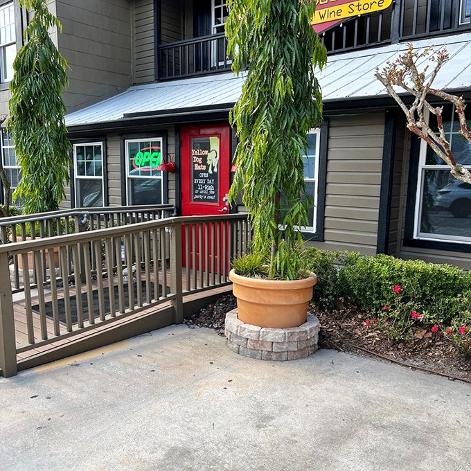 The red door entrance beckons like a portal to sandwich nirvana, framed by weeping willows that seem to know what awaits inside.
