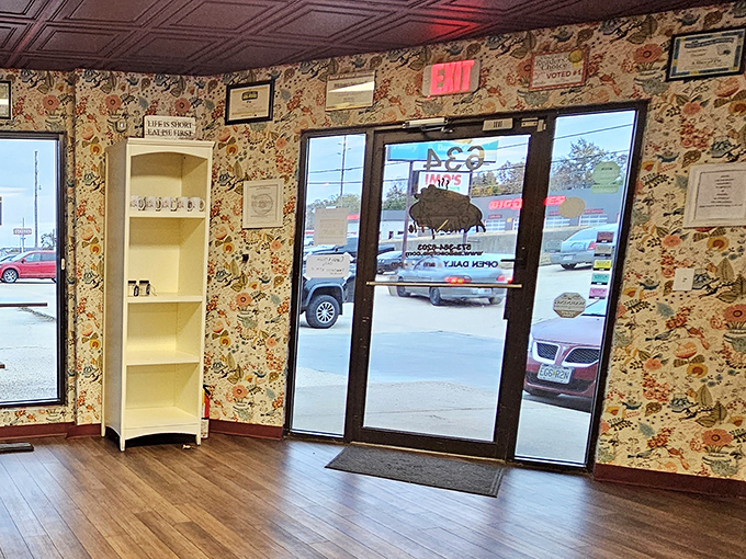 Floral wallpaper and wooden floors welcome visitors like a warm hug. This entrance has witnessed countless expressions of anticipation, followed by the satisfied smiles of departure.