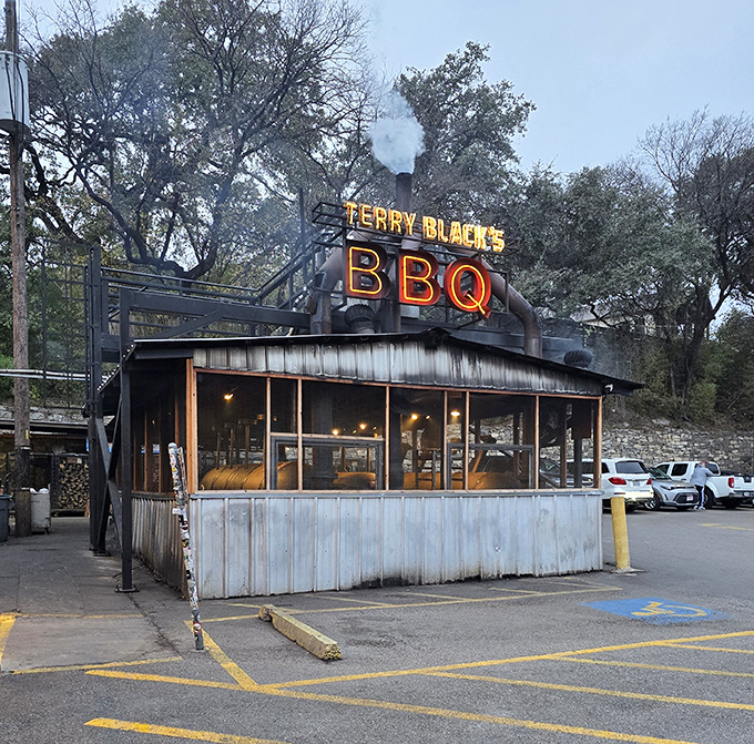 As dusk falls, the Terry Black's sign takes on an almost mystical quality. The smoke rising from the building isn't pollution&mdash;it's a promise.
