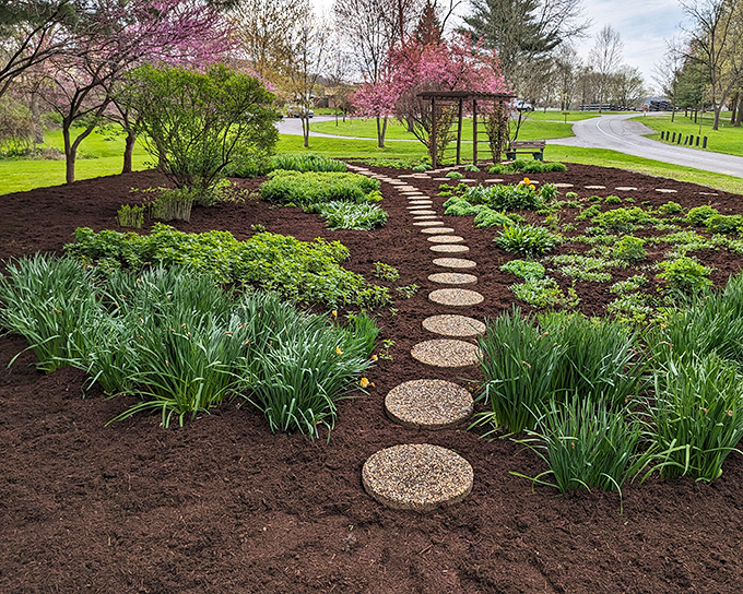 Garden paths that would make even dedicated couch potatoes consider taking up walking as a hobby. Spring brings an explosion of color worth every sneeze.
