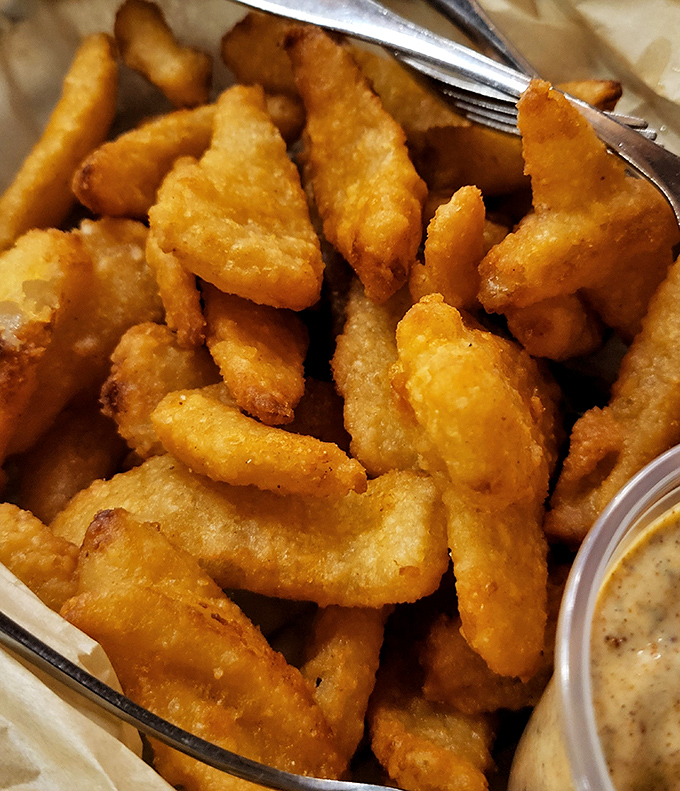 Golden-brown onion petals that shatter with each bite, revealing sweet, tender interiors. The perfect companion to an ice-cold beverage.