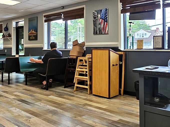 Natural light streams through windows framing a quiet corner where solo diners can enjoy both their meal and a moment of peaceful contemplation.