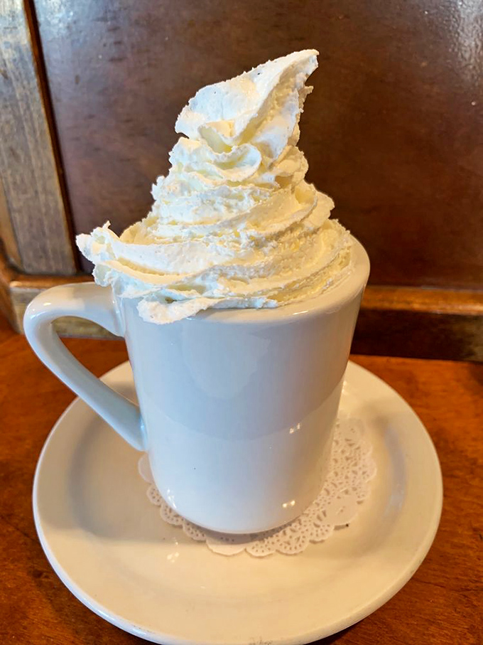 Hot chocolate that doesn't know it's not dessert, topped with a whipped cream mountain that requires its own zip code.