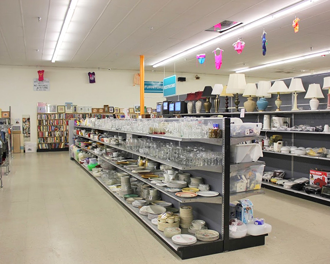 Glassware and dishes that once graced someone else's table now await your dinner party debut. The dishware aisle stretches toward the book section like a culinary library.