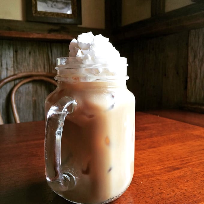 Coffee served with a side of history. This mason jar creation topped with whipped cream proves everything tastes better when surrounded by 150-year-old architecture.