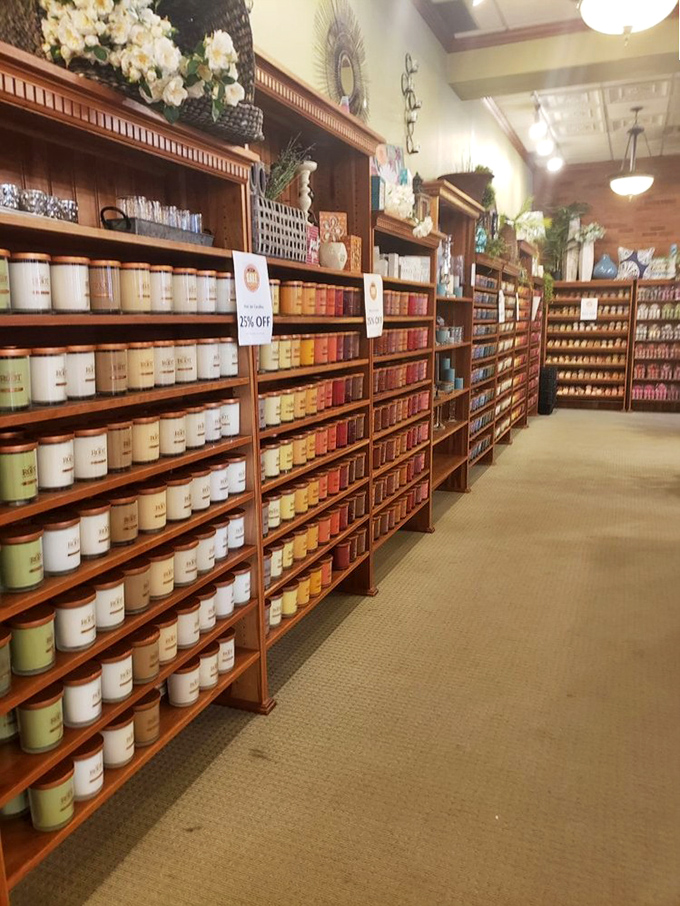 Candle heaven stretches as far as the eye can see. The wooden shelving and organized color progression create an almost library-like reverence for scent.