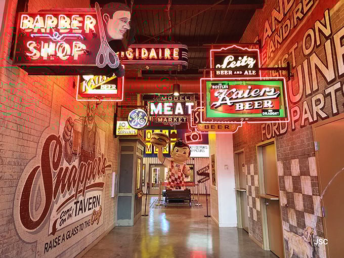 Barber poles and beer signs create a neighborhood of nostalgia. This corridor captures the commercial landscape of mid-century America with glowing precision.