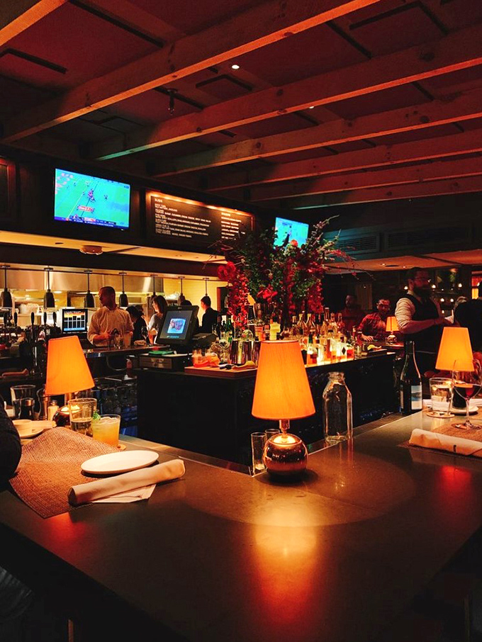 Evening transforms the bar into a warm sanctuary of amber light and conversation&mdash;where strangers become friends over perfectly mixed cocktails.