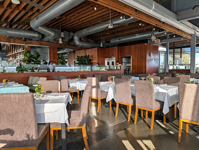 White tablecloths and earth-toned chairs create an elegant yet unpretentious dining room where the seafood, not the decor, remains the undisputed star.