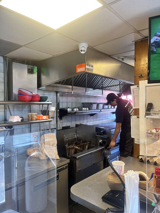 Behind the scenes where the magic happens. Like watching a conductor lead an orchestra of sizzling beef and melting cheese.