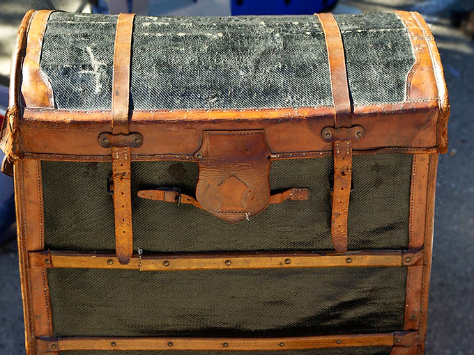 This vintage trunk has likely traveled more interesting places than most of us, carrying secrets and stories beneath its weathered leather straps.