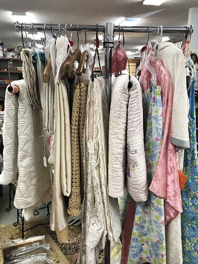 Delicate linens and lace hang like ghosts of fashion past, each garment more intricate than anything in today's "fast fashion" universe.