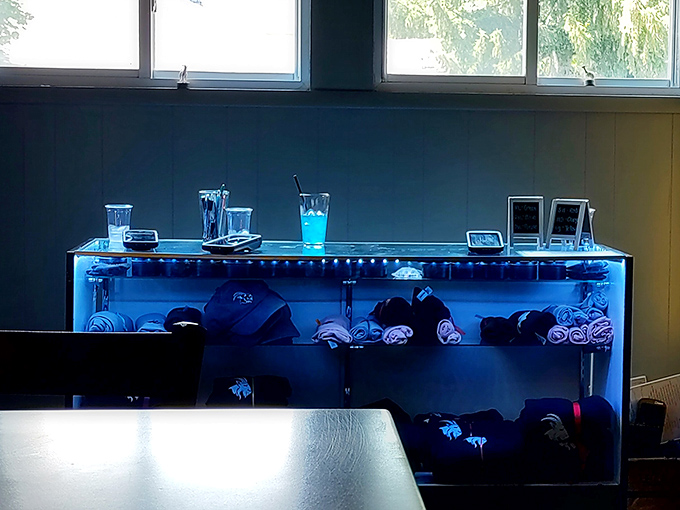 Cool blue lighting showcases GOAT merch in a display that says, "Yes, you should take home a souvenir of this flavor experience."