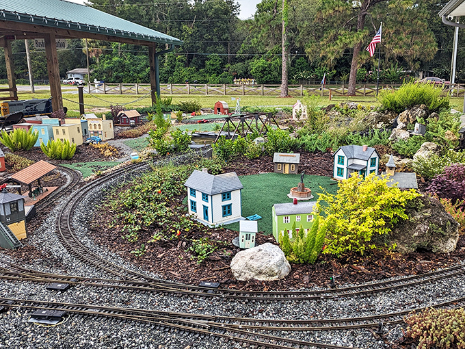 Honey, I shrunk the railroad! This charming garden display features miniature buildings and tiny tracks that would make any model train enthusiast swoon.