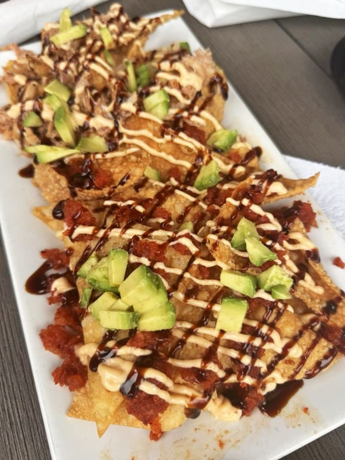 Seafood nachos that break all the rules in the most delicious way possible. The avocado adds creamy contrast to the crispy chips and savory toppings.