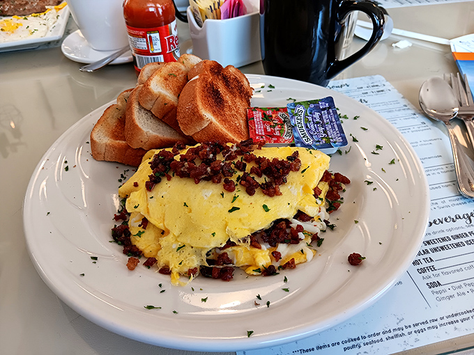 An omelet that clearly went to college and graduated with honors. Those crispy bits of bacon are the valedictorian speech.