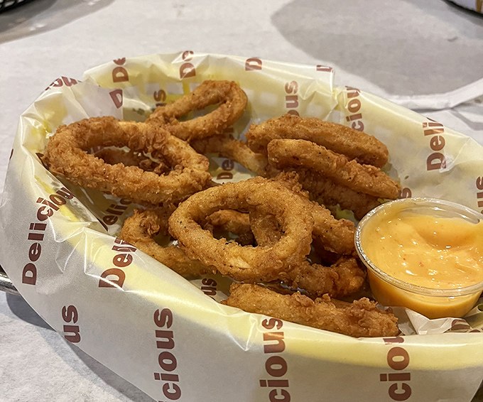 Onion rings that achieve the perfect golden ratio&mdash;crispy exterior giving way to sweet, tender onion within. That dipping sauce isn't optional; it's the exclamation point on every bite. 