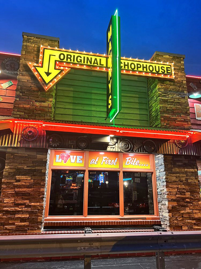 Evening neon transforms this quirky building into a beacon for serious steak lovers everywhere.