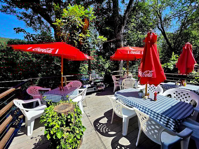 Outdoor dining under Coca-Cola umbrellas feels like summer incarnate. Those checkered tablecloths practically demand a picnic-worthy appetite.