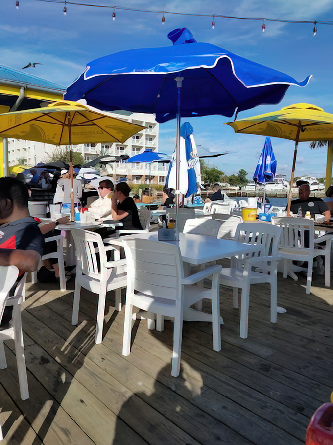 Umbrella-shaded tables offer the perfect spot to enjoy bay breezes while debating which Maryland town truly has the best crab cakes.