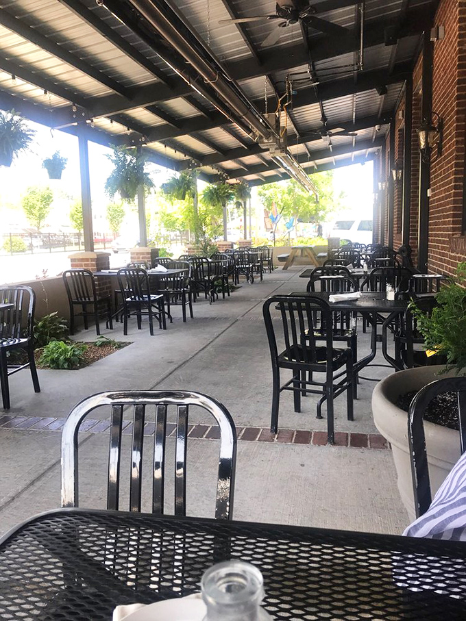 The covered patio offers a breath of fresh air without sacrificing comfort, where hanging plants create the illusion of dining in a secret garden.