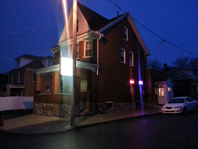 As evening falls, Tim's American Cafe transforms into a beacon of comfort in the neighborhood, promising warm food and warmer welcomes inside.