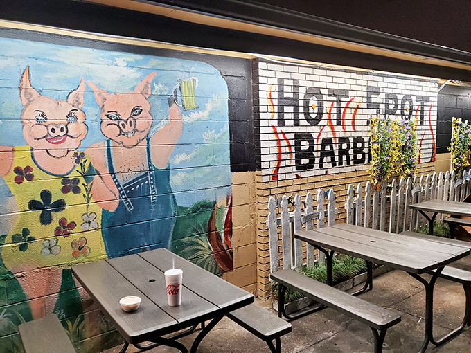 Outdoor seating featuring cartoon pigs who seem suspiciously happy about their role in this establishment. Irony tastes delicious in the Florida sunshine.