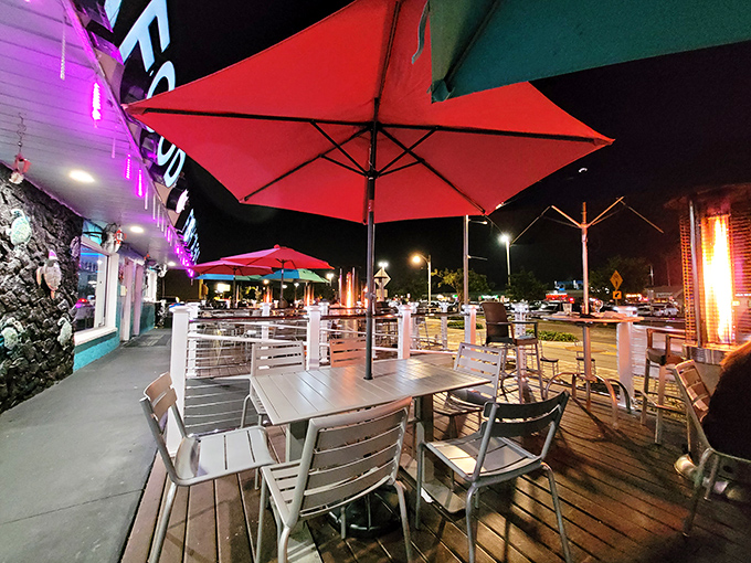 The outdoor patio offers al fresco dining under the stars. Red umbrellas and heat lamps ensure comfort while the night air seasons your seafood feast.